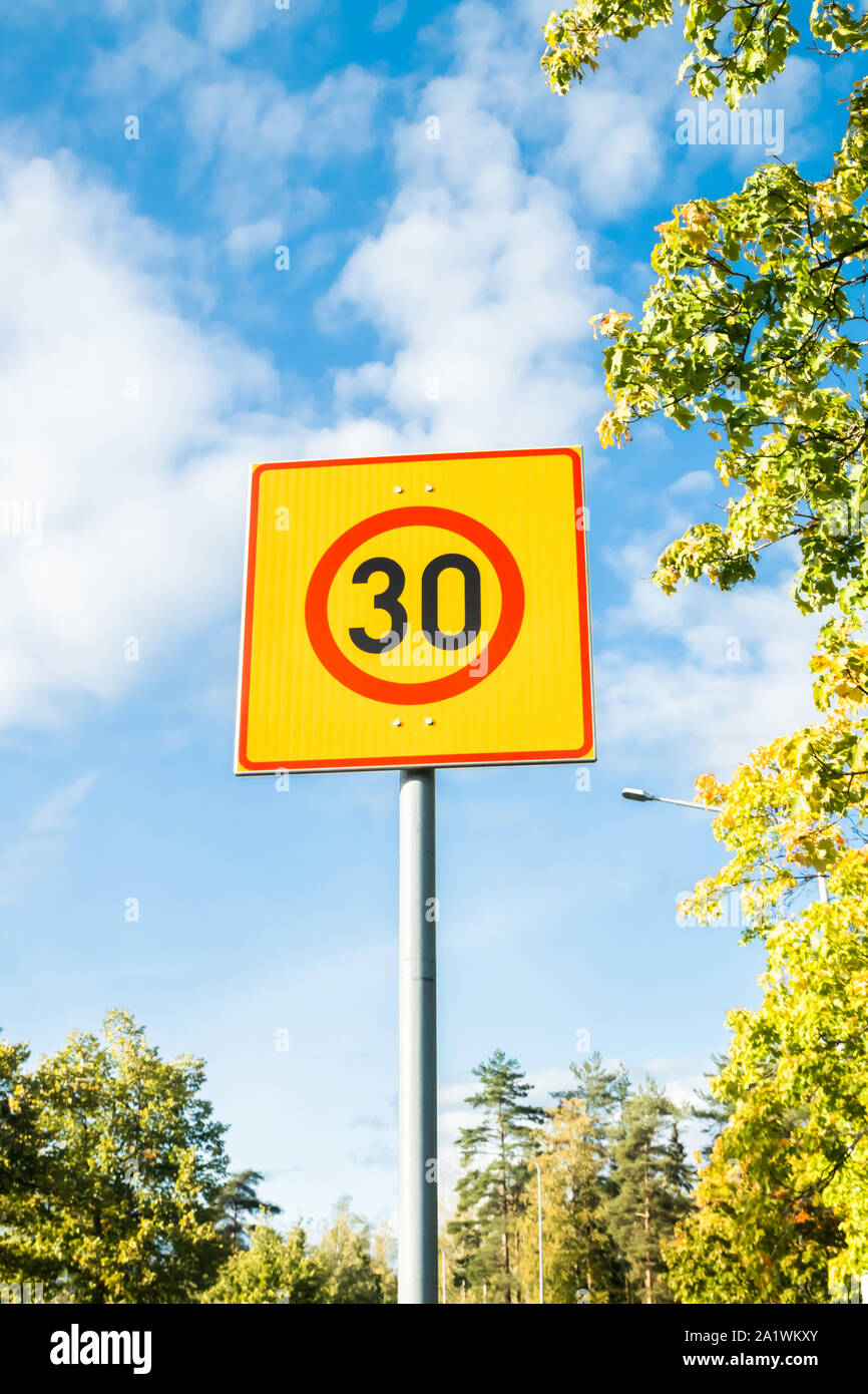 Finnish speed limit sign 30 km h on blue sky background Stock Photo - Alamy