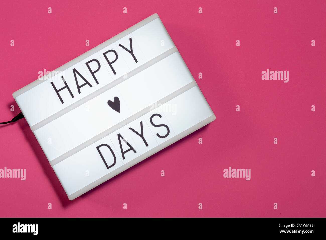lightbox with happy days message on a pink background Stock Photo - Alamy