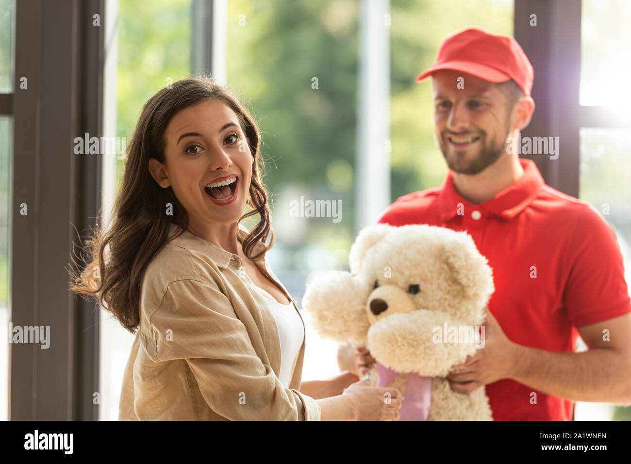 selective focus of positive girl receiving teddy bear from bearded man ...