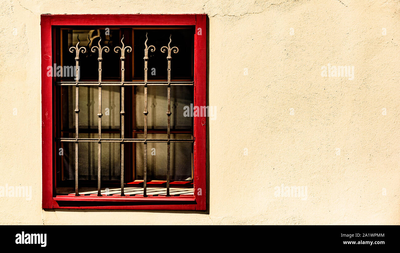 Window with red frame and metal grid Stock Photo - Alamy