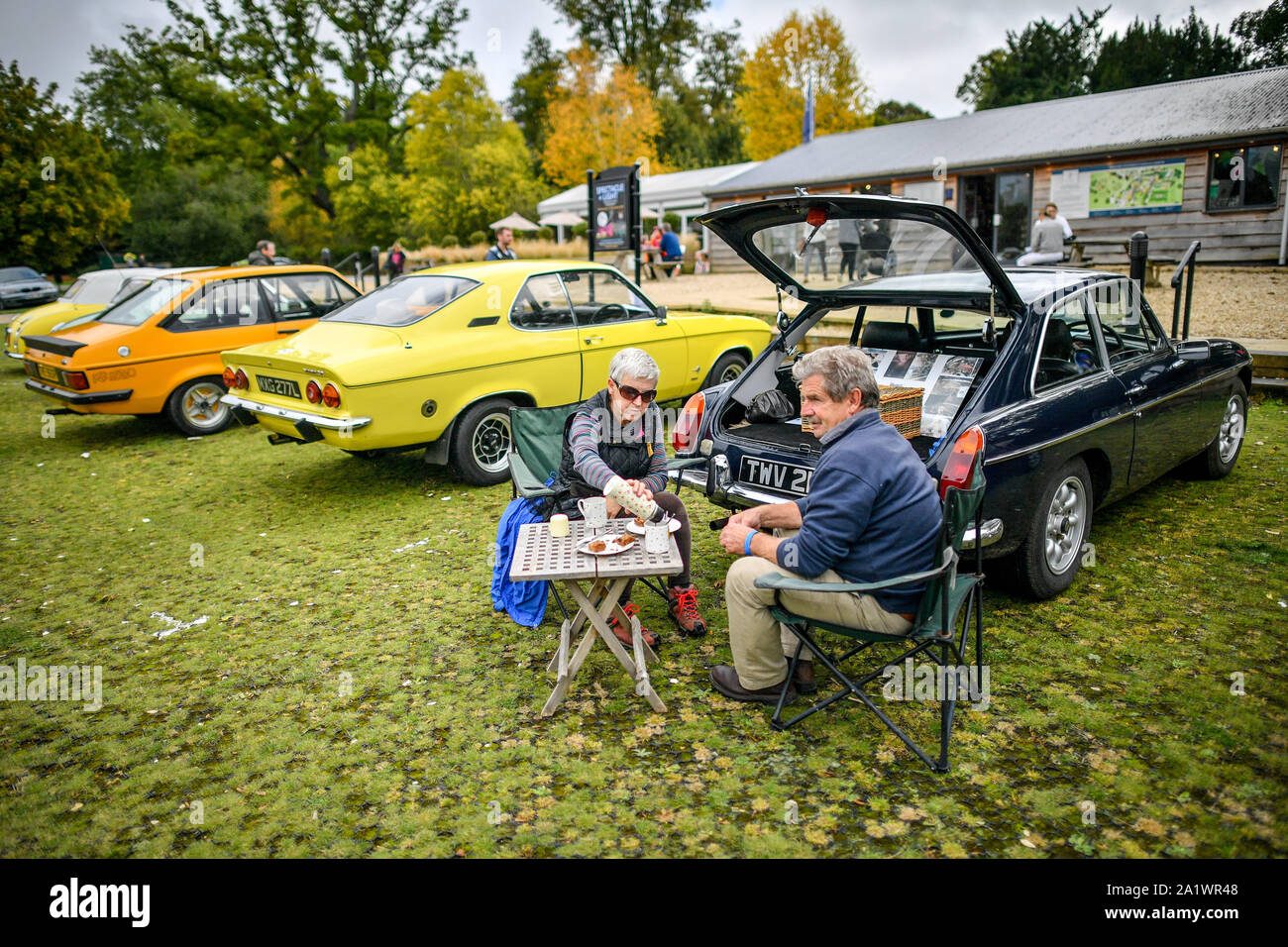 A couple have a picnic at a classic car gathering at Sudeley Castle ...