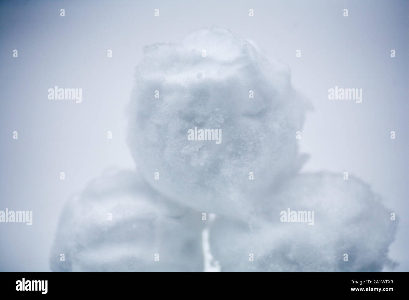 real snowballs with their hands clasped from the fresh snow in winter ...