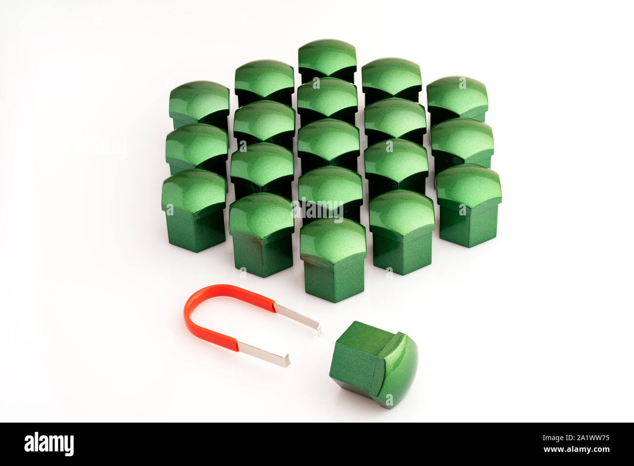 colored caps for automotive nuts or bolts, green. Close up white ...