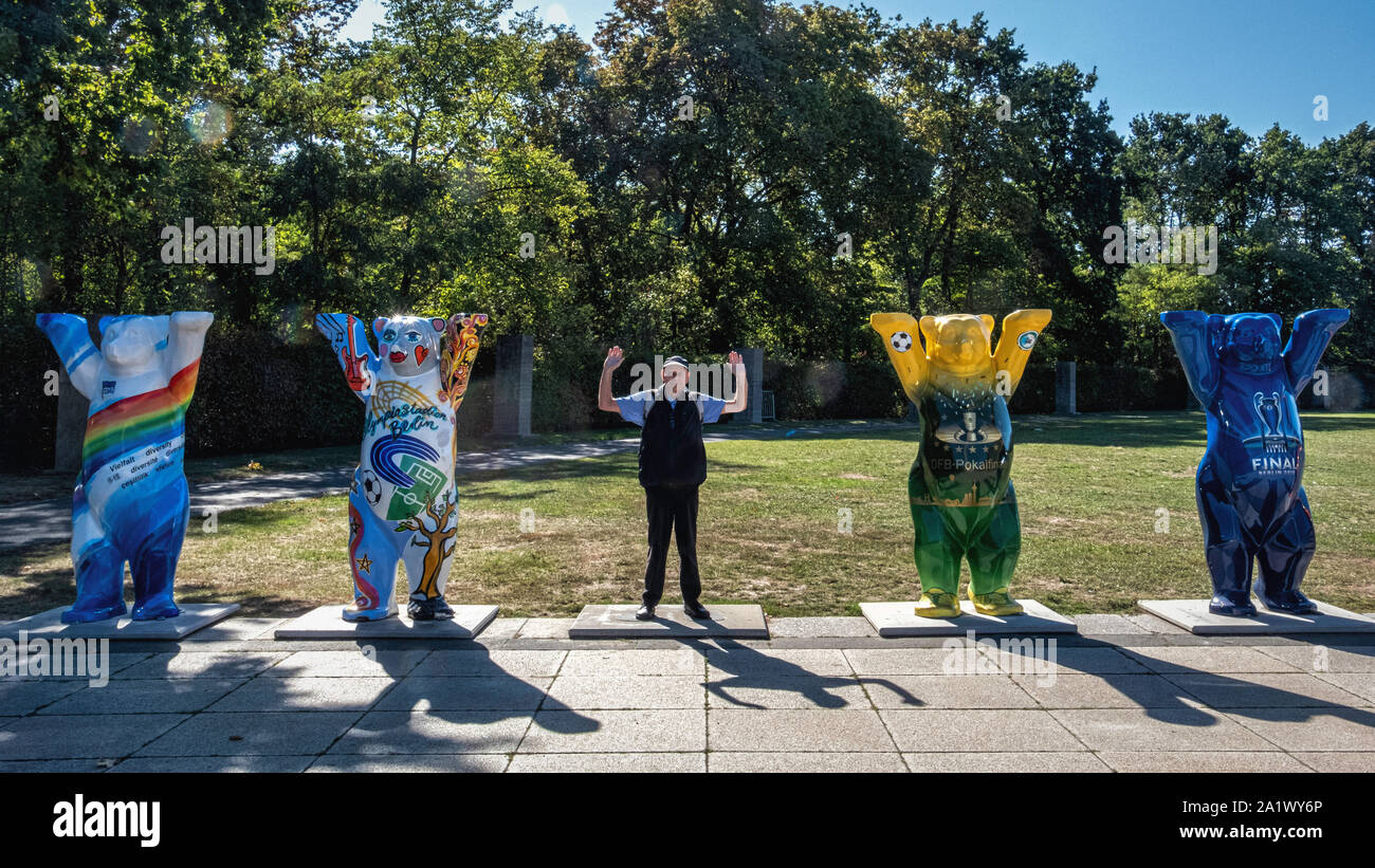 Elderly male tourist & Buddy Bears in the grounds of Olympic STadium ...