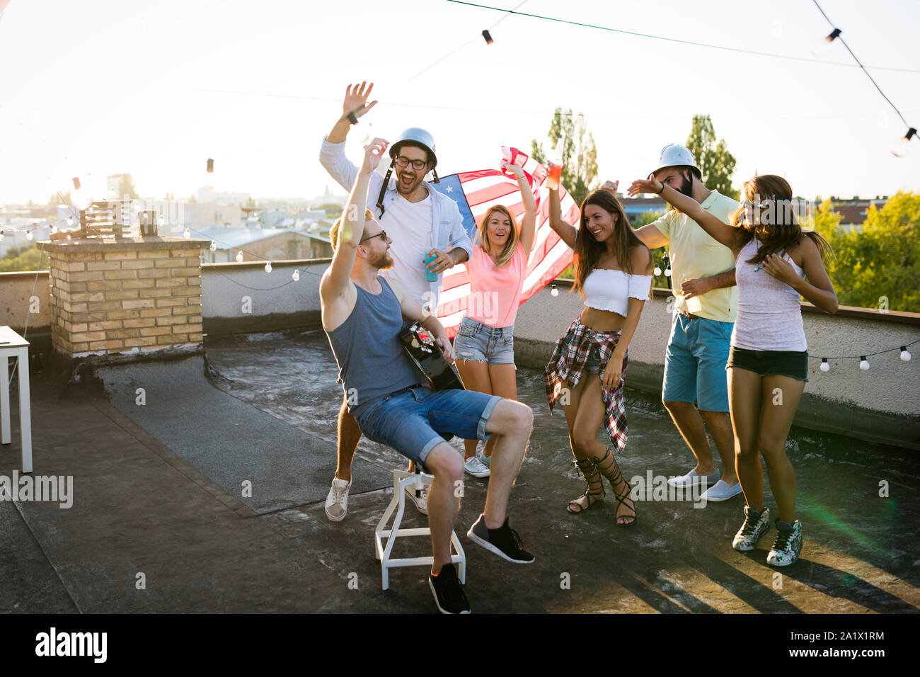 Group of happy friends having party on rooftop Stock Photo - Alamy