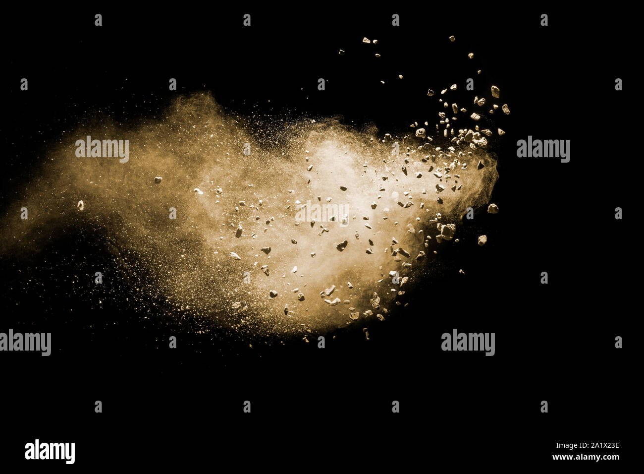 Split debris of brown stone exploding with brown powder against black ...