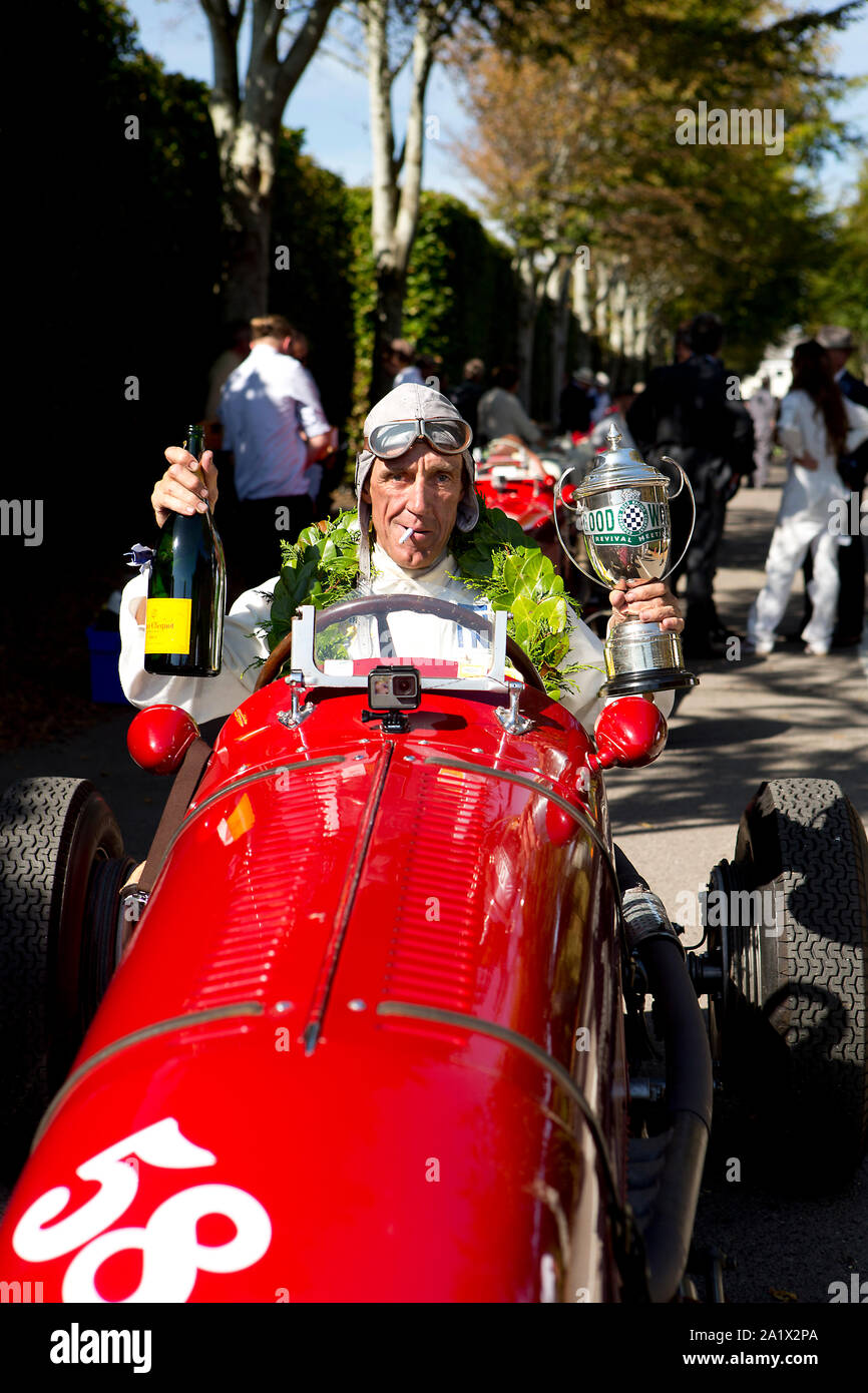 Graeme Hardy holding trophy and bottle of champagne, (tribute actor ...