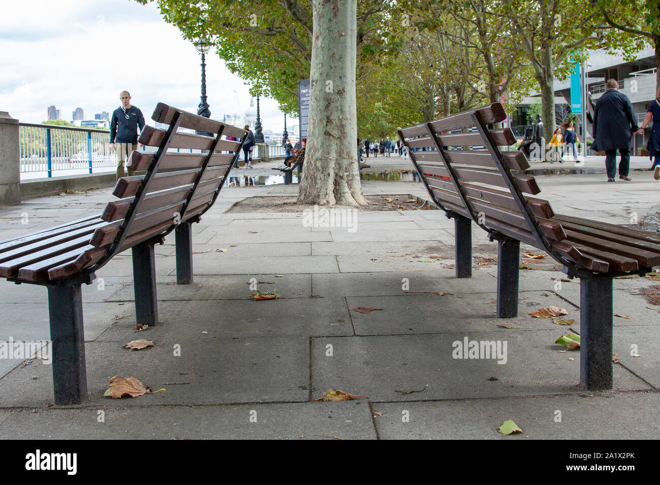Benches side by side on London's south bank Stock Photo - Alamy