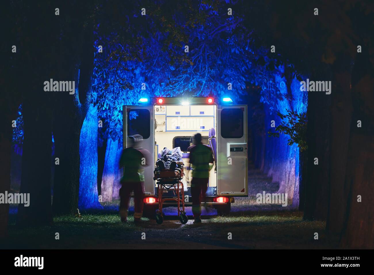 Doctor and paramedic of emergency medical service rescuing old patient ...