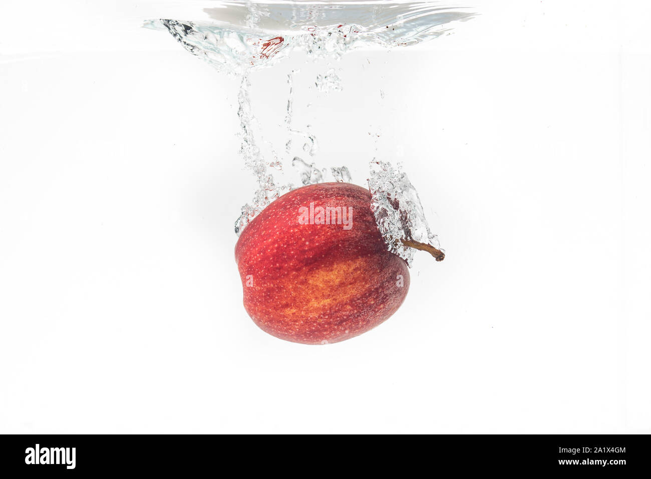 Apple falls under water with a splash Stock Photo - Alamy