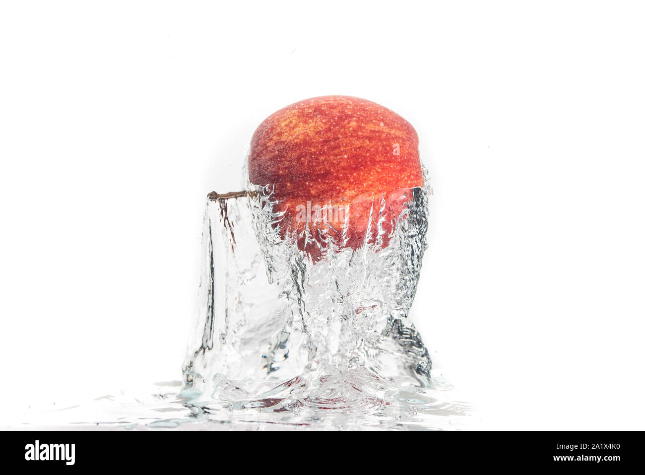 Apple falls under water with a splash Stock Photo - Alamy