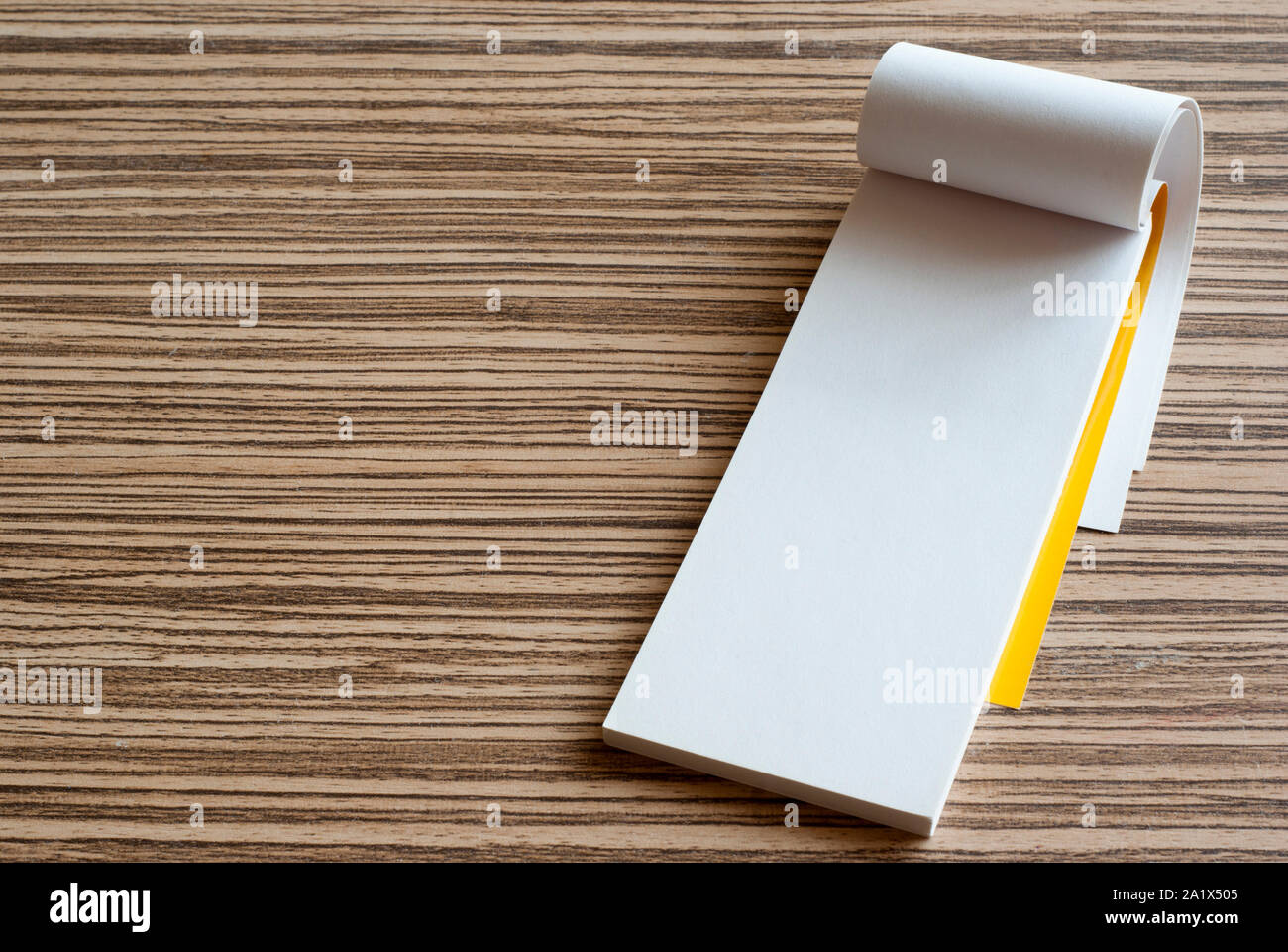 Blank white paper page of writing pad on wooden background Stock Photo ...