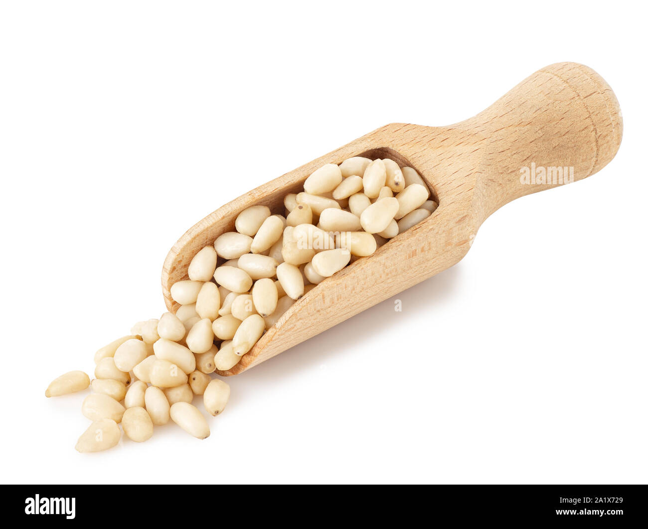 peeled cedar nuts in wooden scoop isolated on white background Stock ...