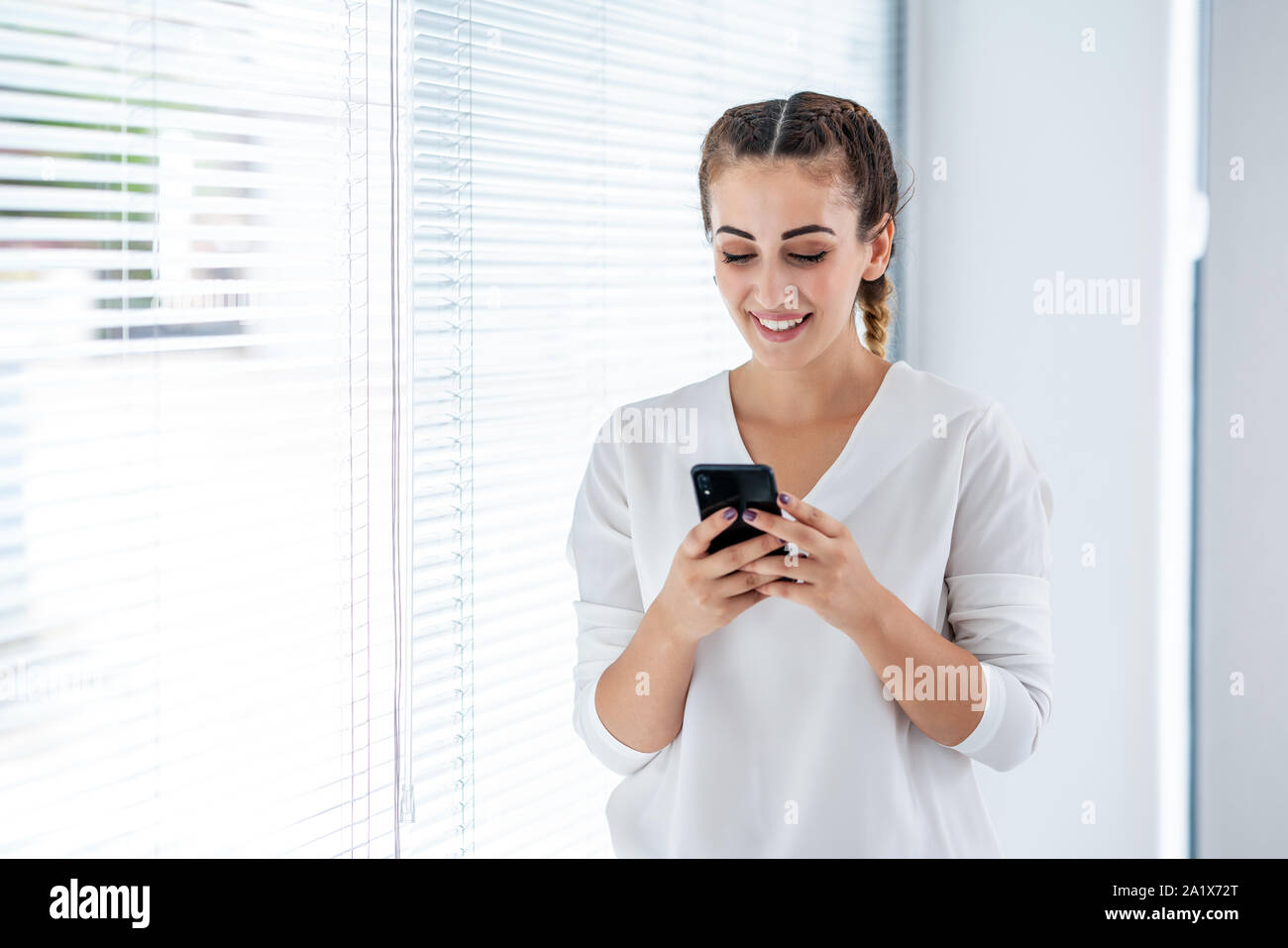 happy business woman getting message on the phone Stock Photo - Alamy