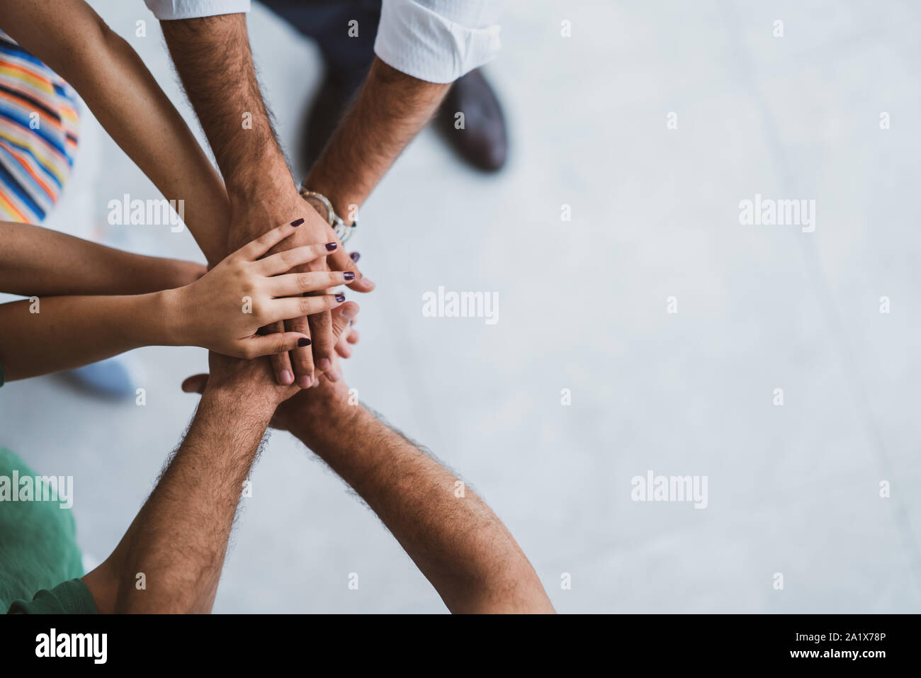 Stack of hands showing unity and teamwork for success Stock Photo - Alamy