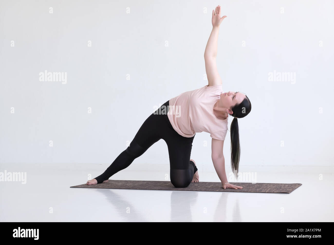Young woman doing Side Plank Posture, Pose of Vashista, Vasisthasana ...