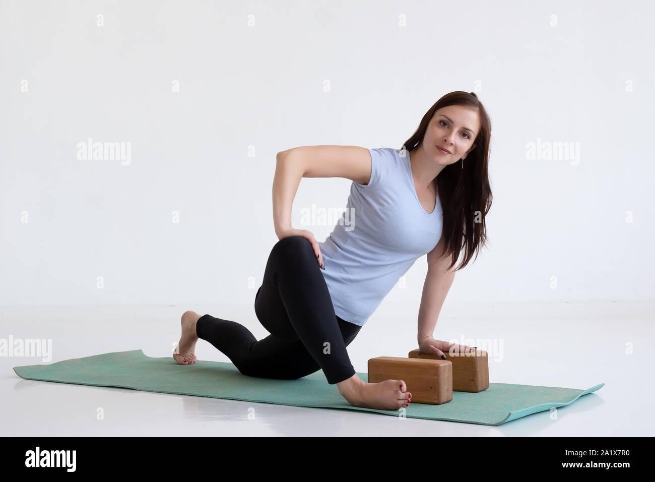 Young caucasian woman doing stretching exercise, Utthan Pristhasana ...
