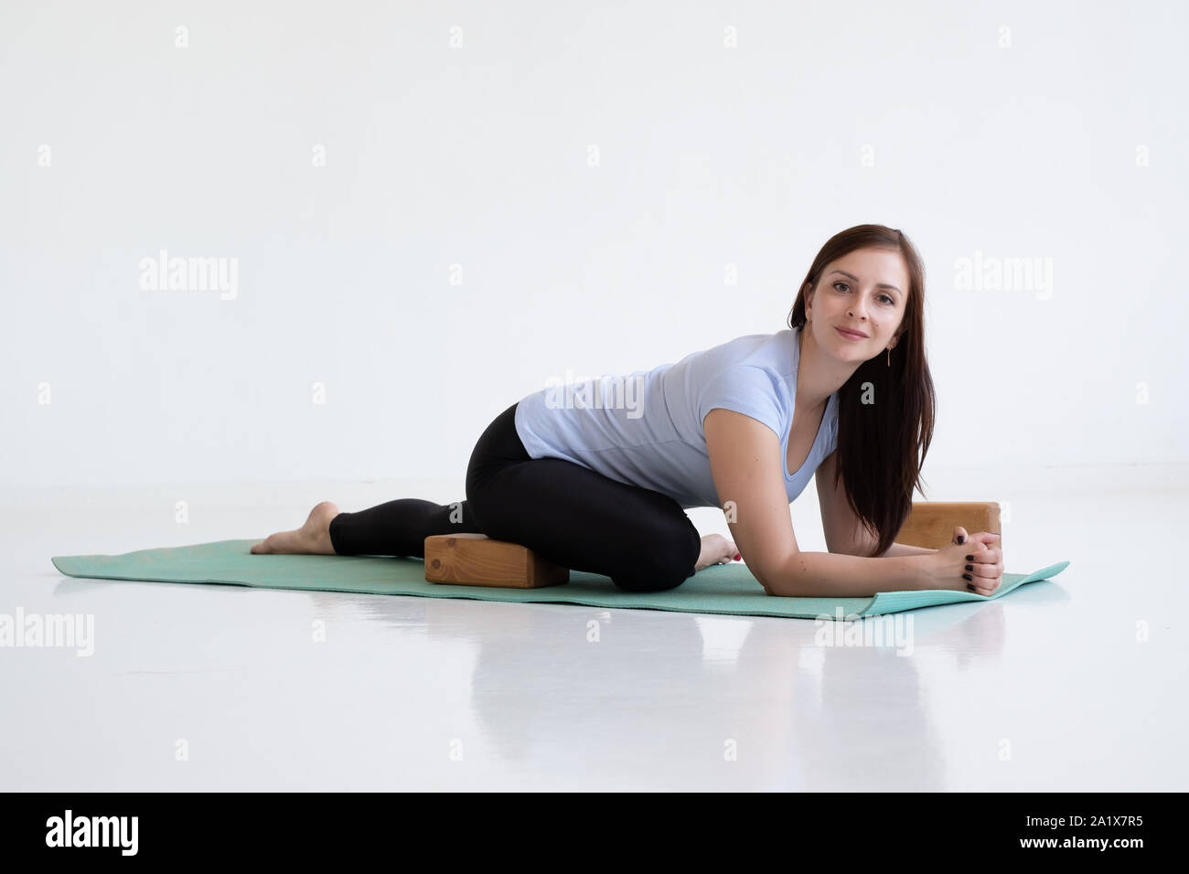 Young caucasian woman doing stretching exercise, Utthan Pristhasana ...