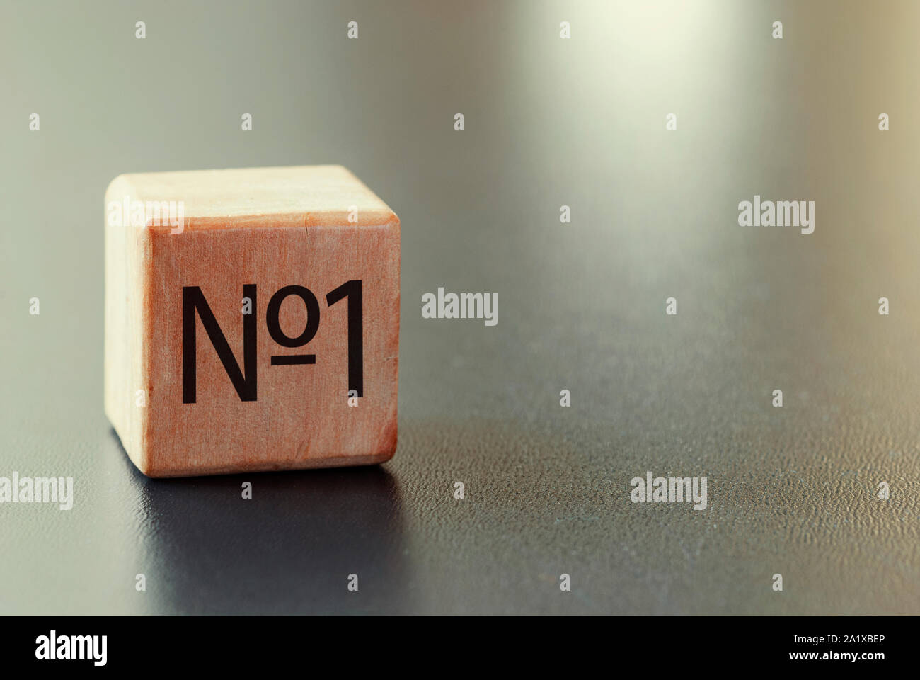 Wooden block with No 1 text in black over a grey background with ...