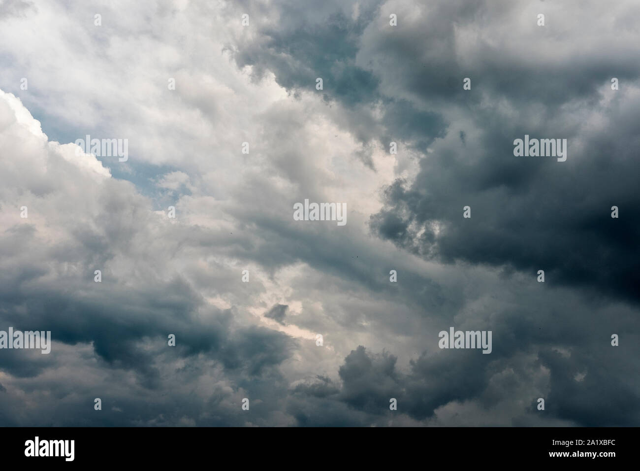 Background of dramatic grey storm clouds in an atmospheric sky in a ...
