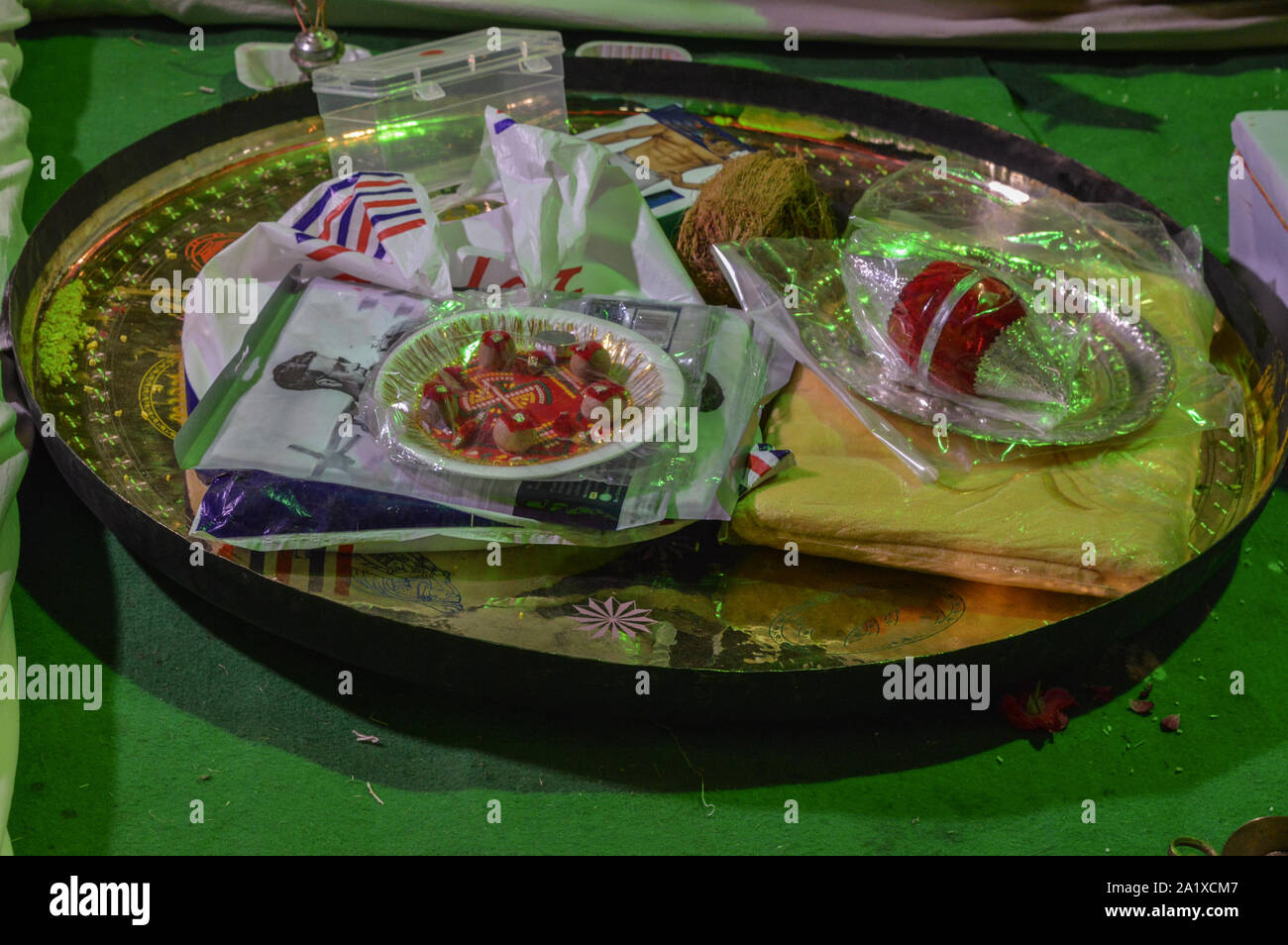 A plate which is loaded with betel nut, silver, coconut, in one of the ...