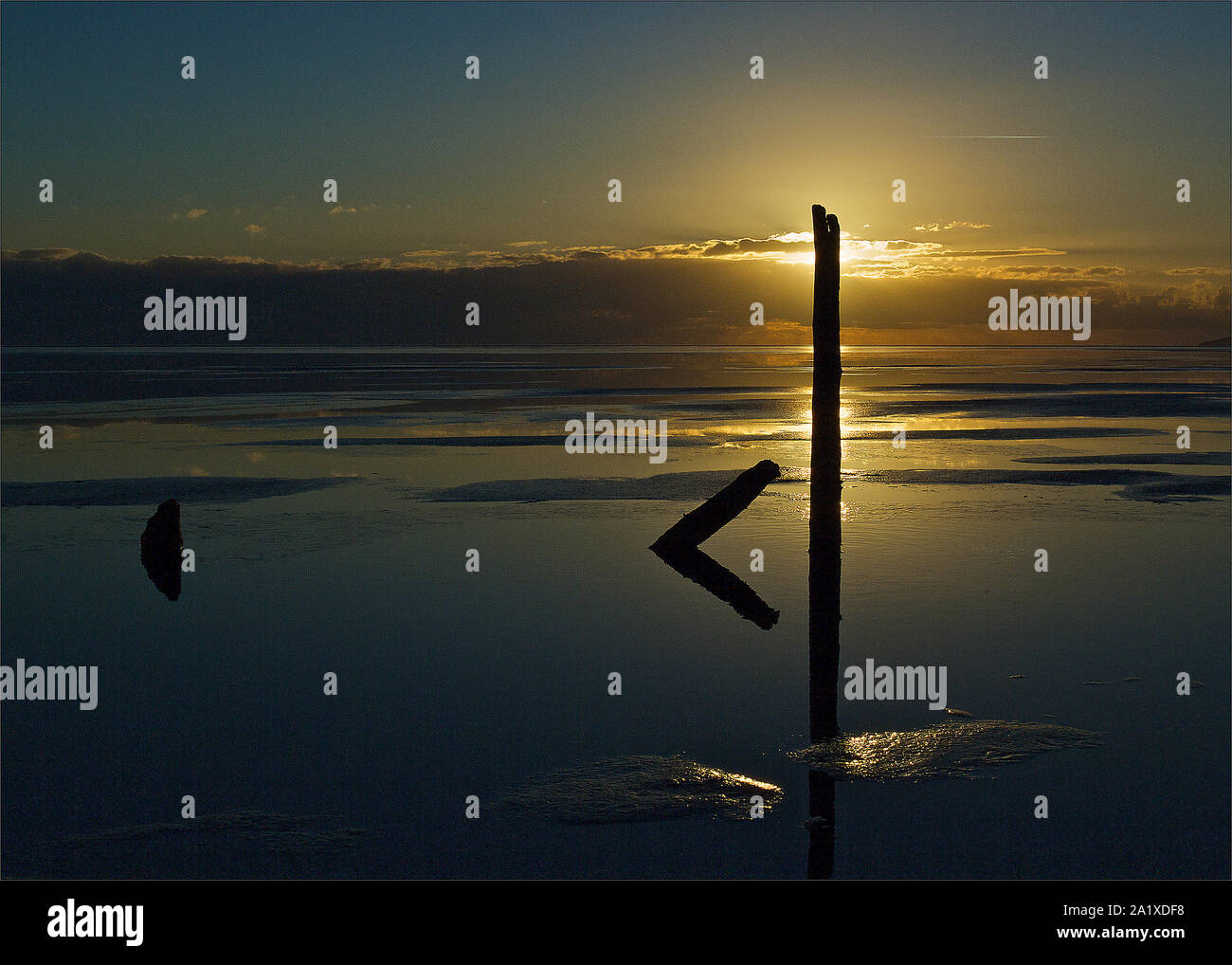 Sunset across the sand at Mersehead - abandoned stake net posts in ...