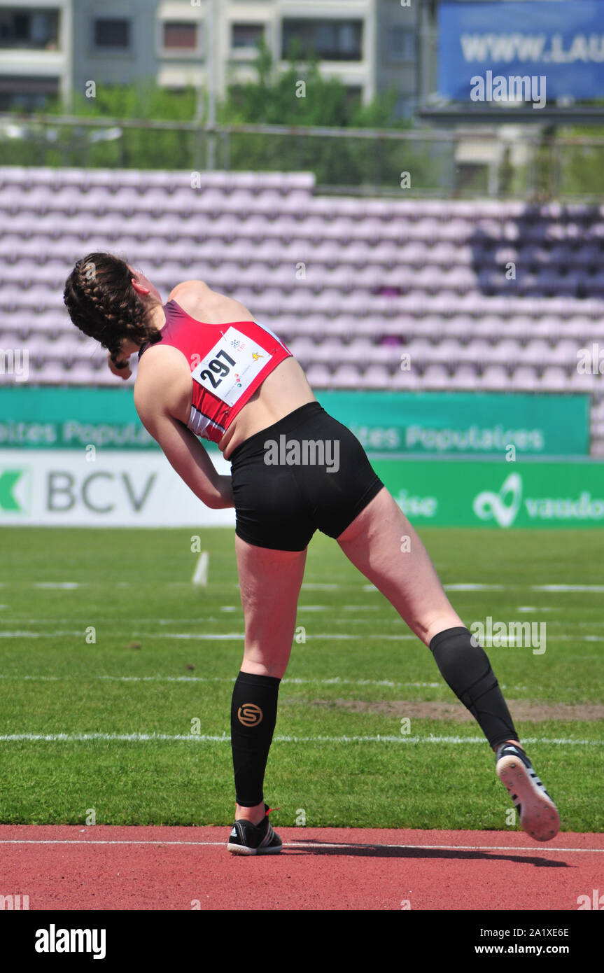 Young female athlete at the end of her throw, the release, in a typical ...