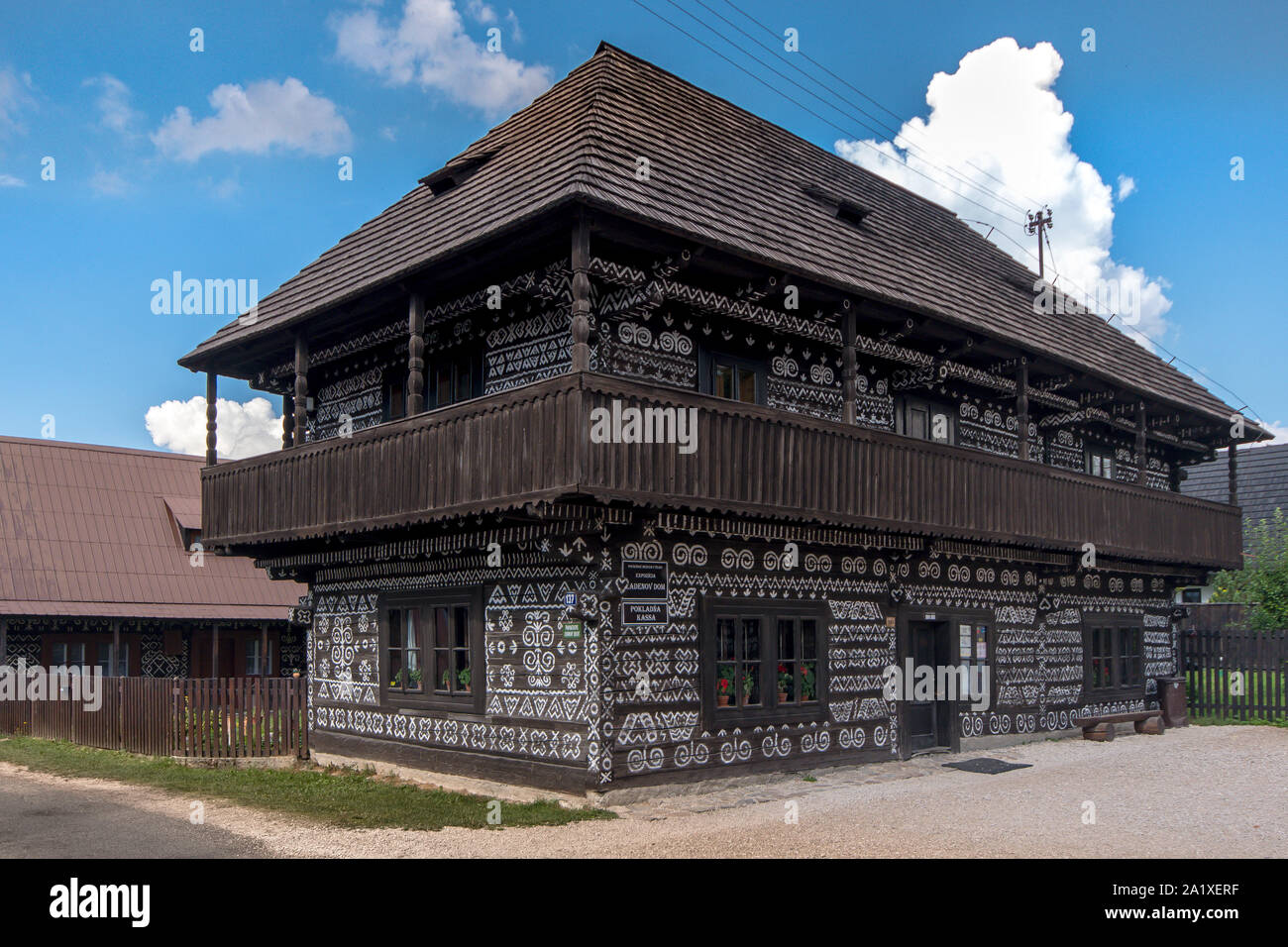Old wooden houses with a painted traditional pattern. Museum, part of ...