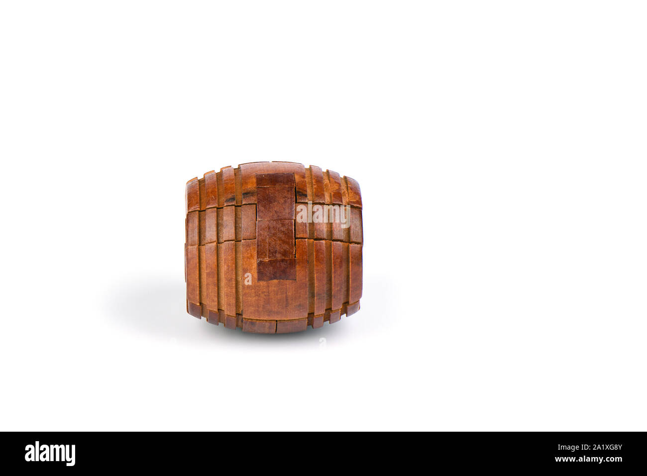 The wooden puzzle barrel is fully assembled isolated on a white ...