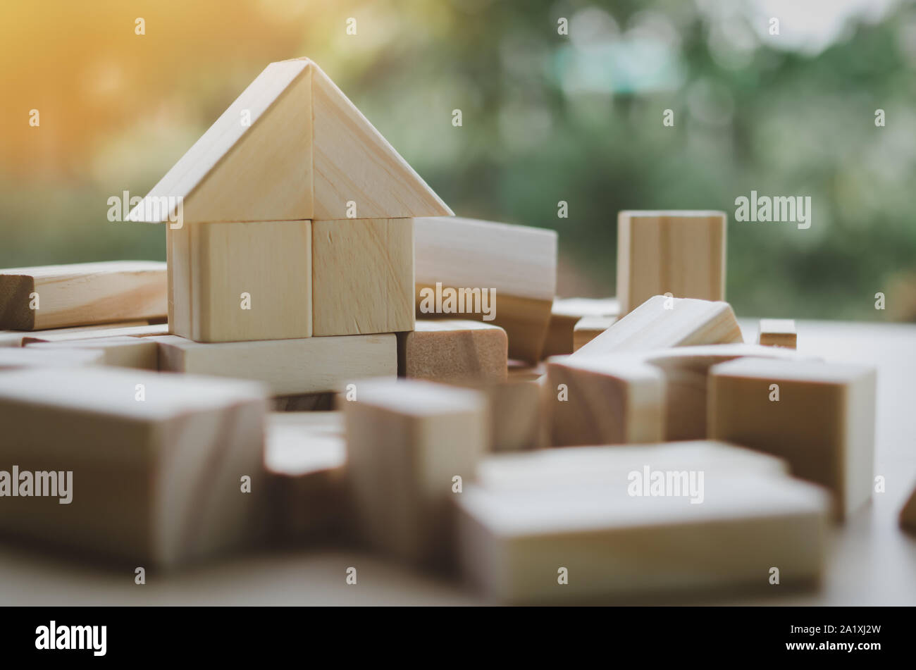 house from natural color wooden block on the stack of wooden blocks ...