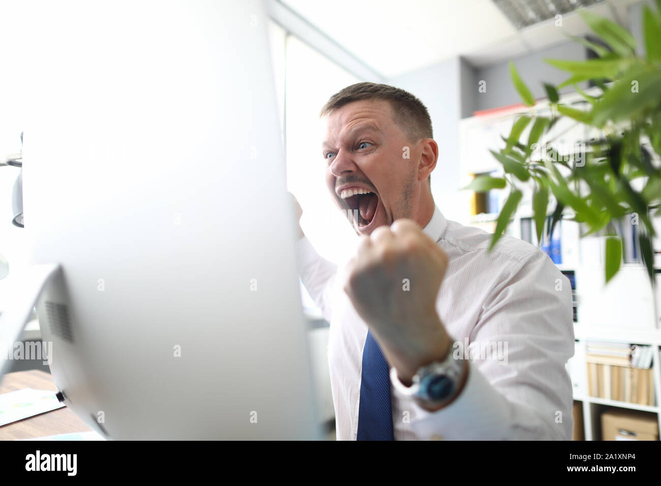 Crazy boss screams threatens with a fist and looks Stock Photo - Alamy
