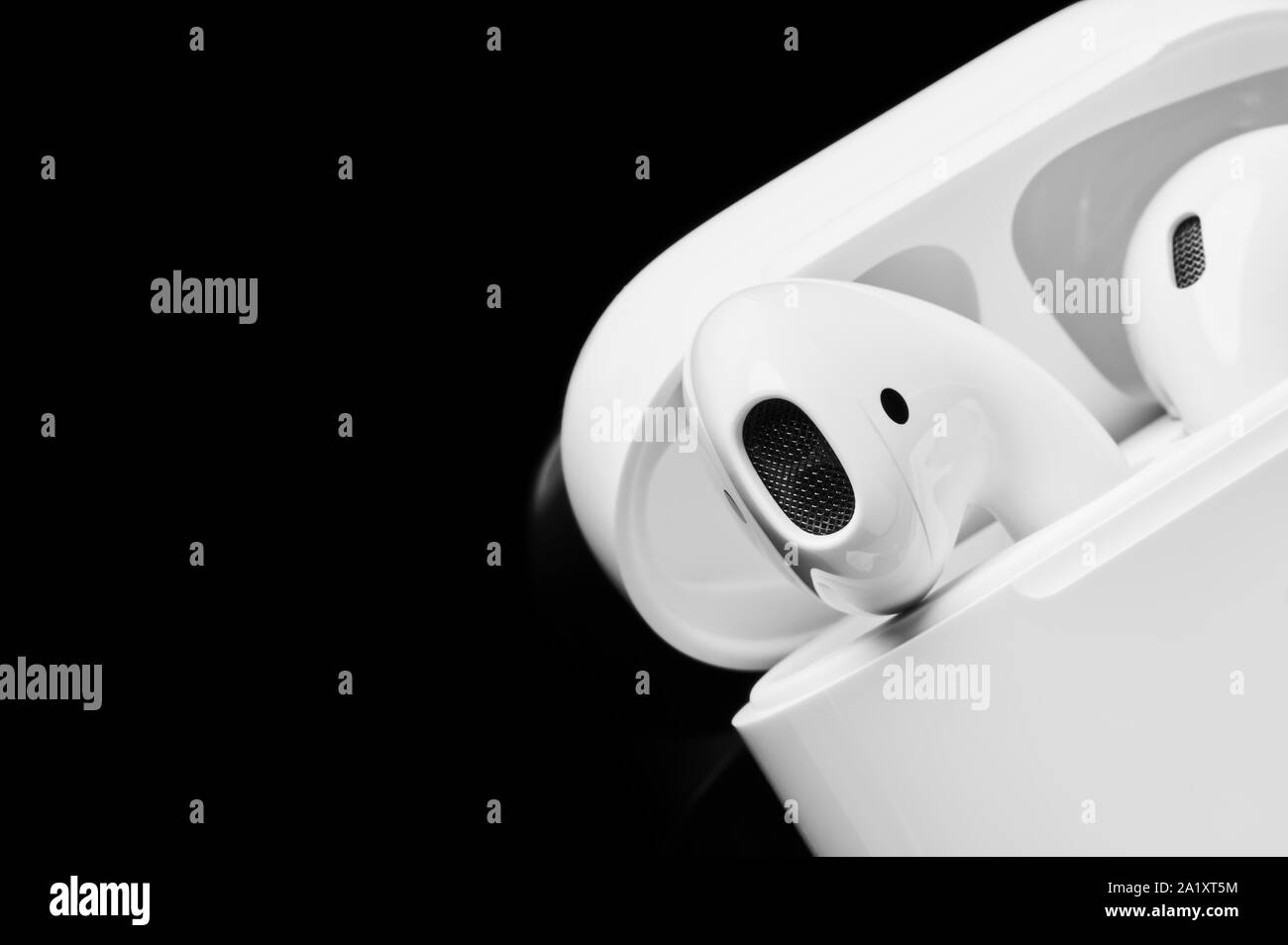 White wireless earphones or headphones in plastic case or box for ...