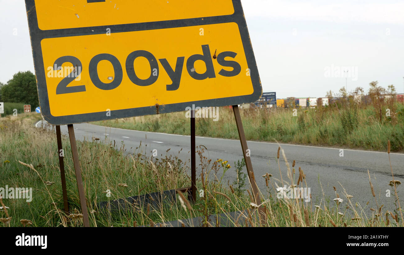 200 yards roadworks warning sign on UK motorway at evening with traffic ...