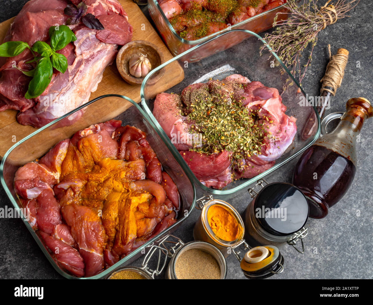 Raw meat background. with a variety of herbs and spices as basil ...