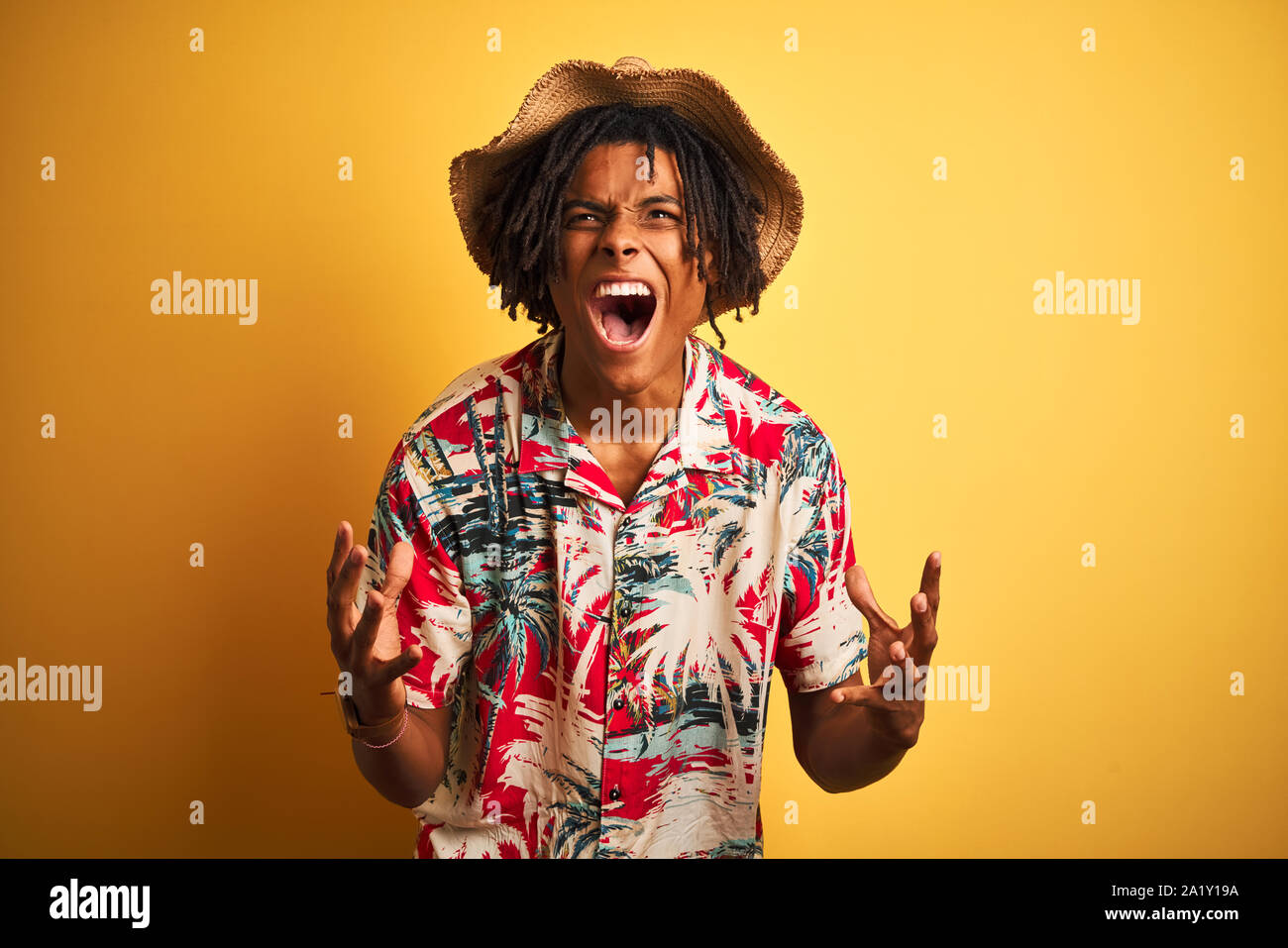 Afro american man with dreadlocks wearing floral shirt and hat over ...