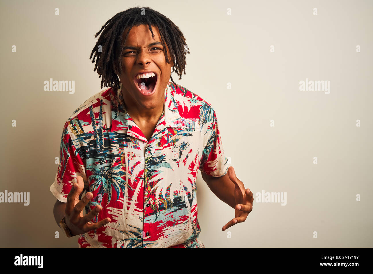 Afro man with dreadlocks on vacation wearing summer shirt over isolated ...