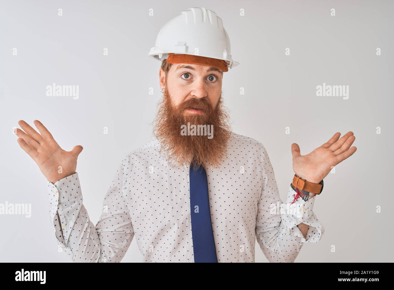 Young redhead irish architect man wearing security helmet over isolated ...