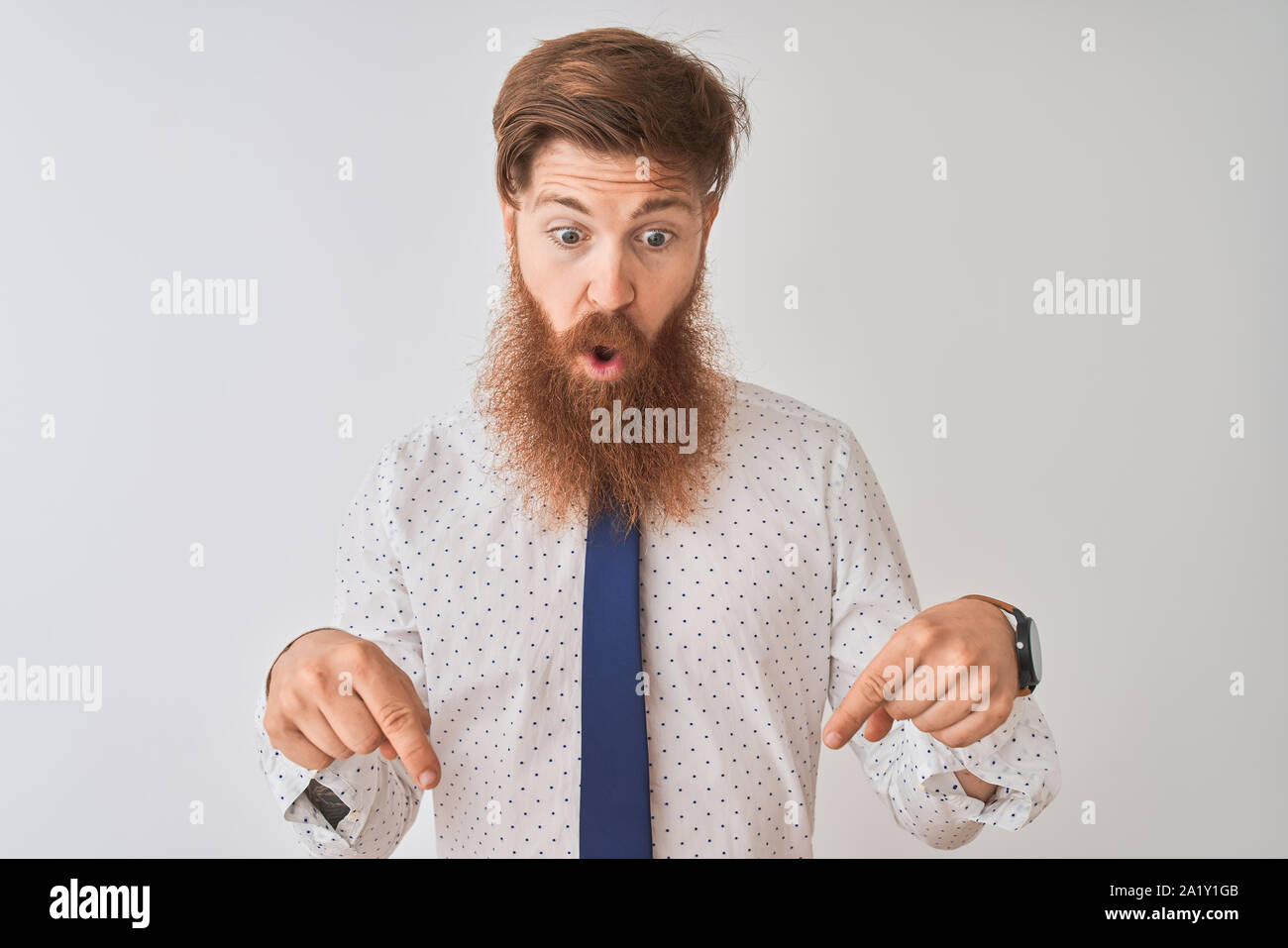 Young redhead irish businessman standing over isolated white background ...