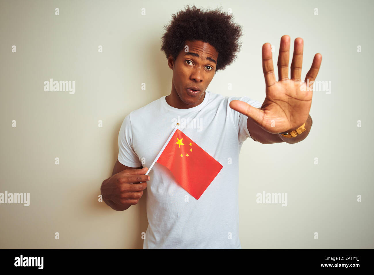 Young afro american man holding China Chinese flag standing over ...