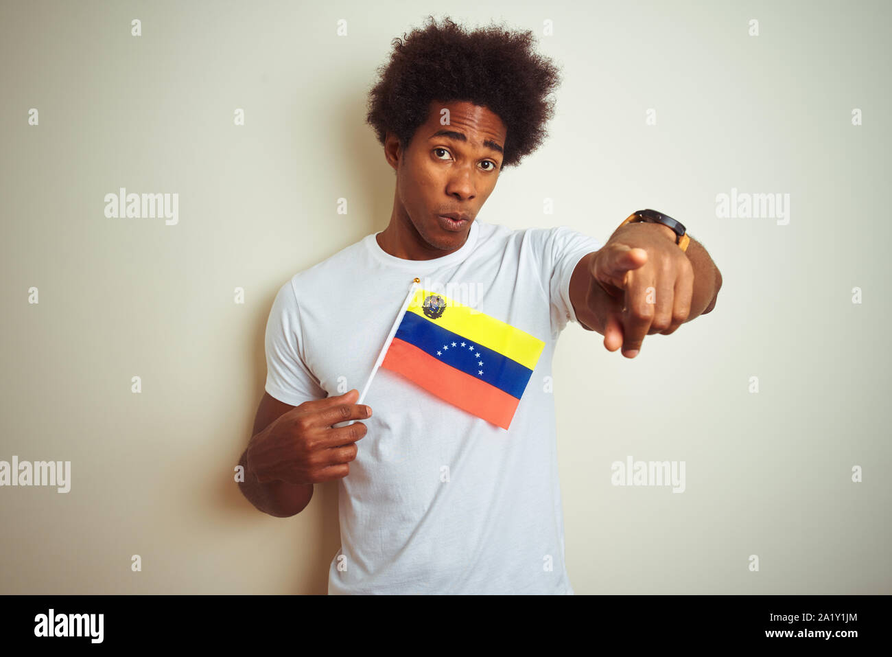 Afro american man holding Venezuela Venezuelan flag standing over ...