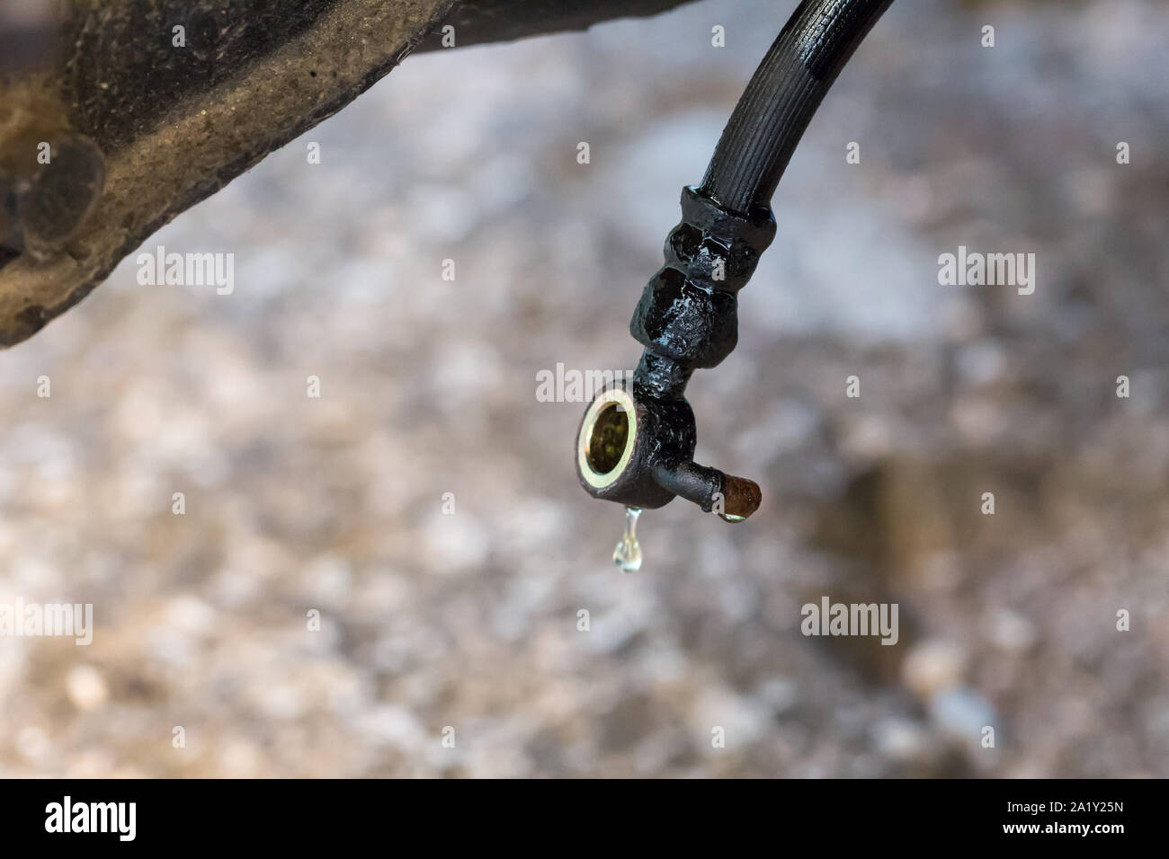 Brake line hose with dripping brake fluid Stock Photo - Alamy