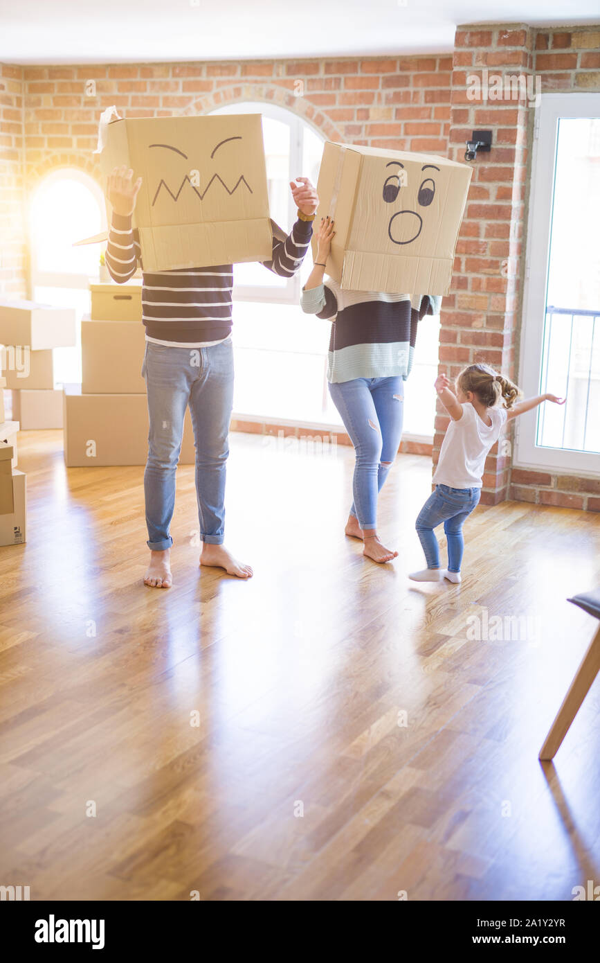 Beautiful famiily with kid playing with cardboard fanny boxes at new ...