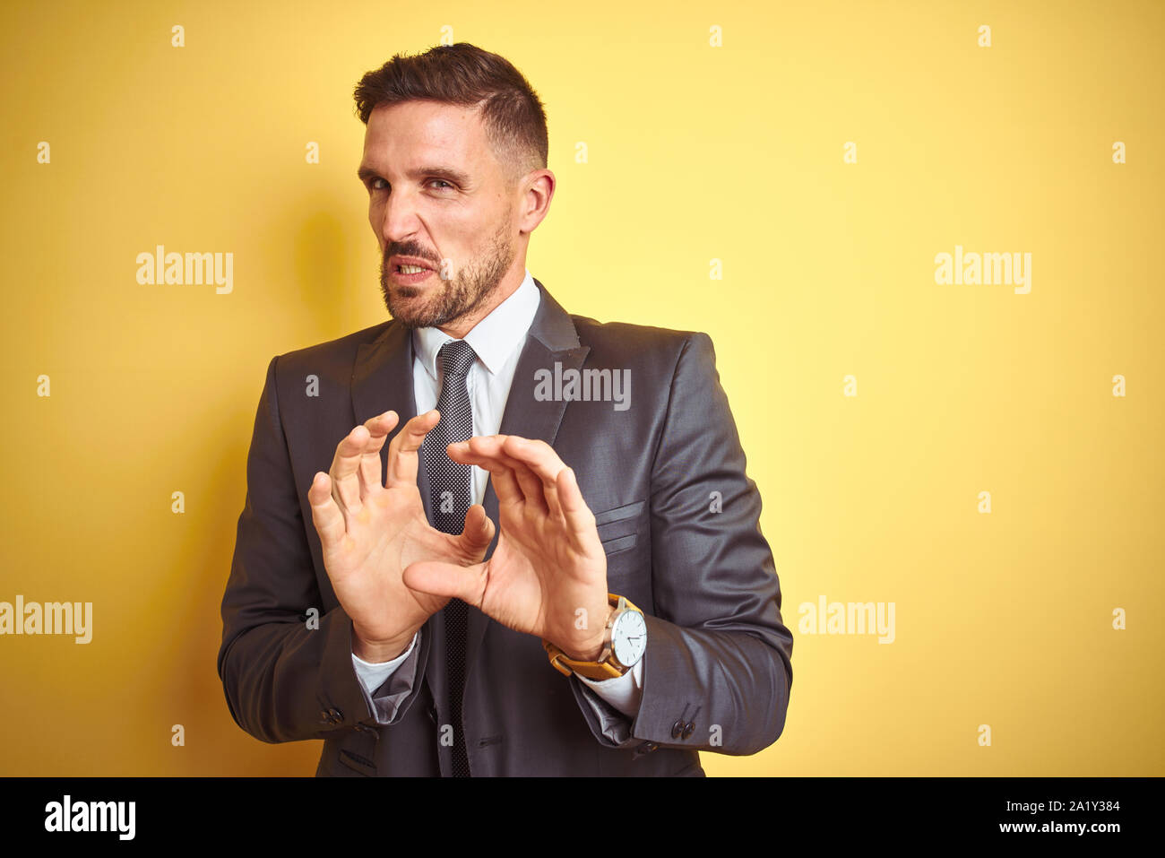 Young handsome business man over yellow isolated background disgusted ...