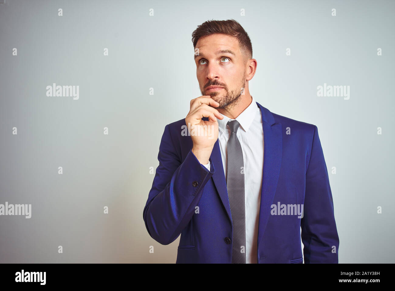 Young handsome business man over white isolated background with hand on ...
