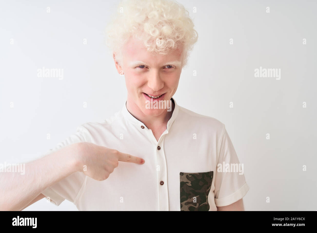 Young albino blond man wearing casual shirt standing over isolated ...