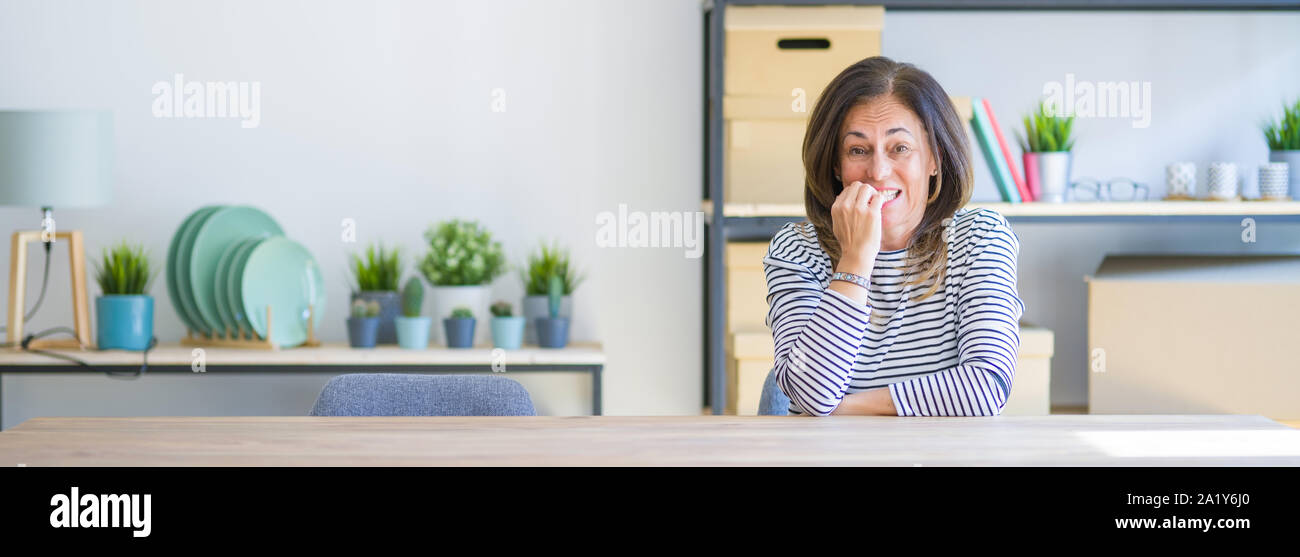 Wide angle photo of middle age senior woman sitting at the table at ...