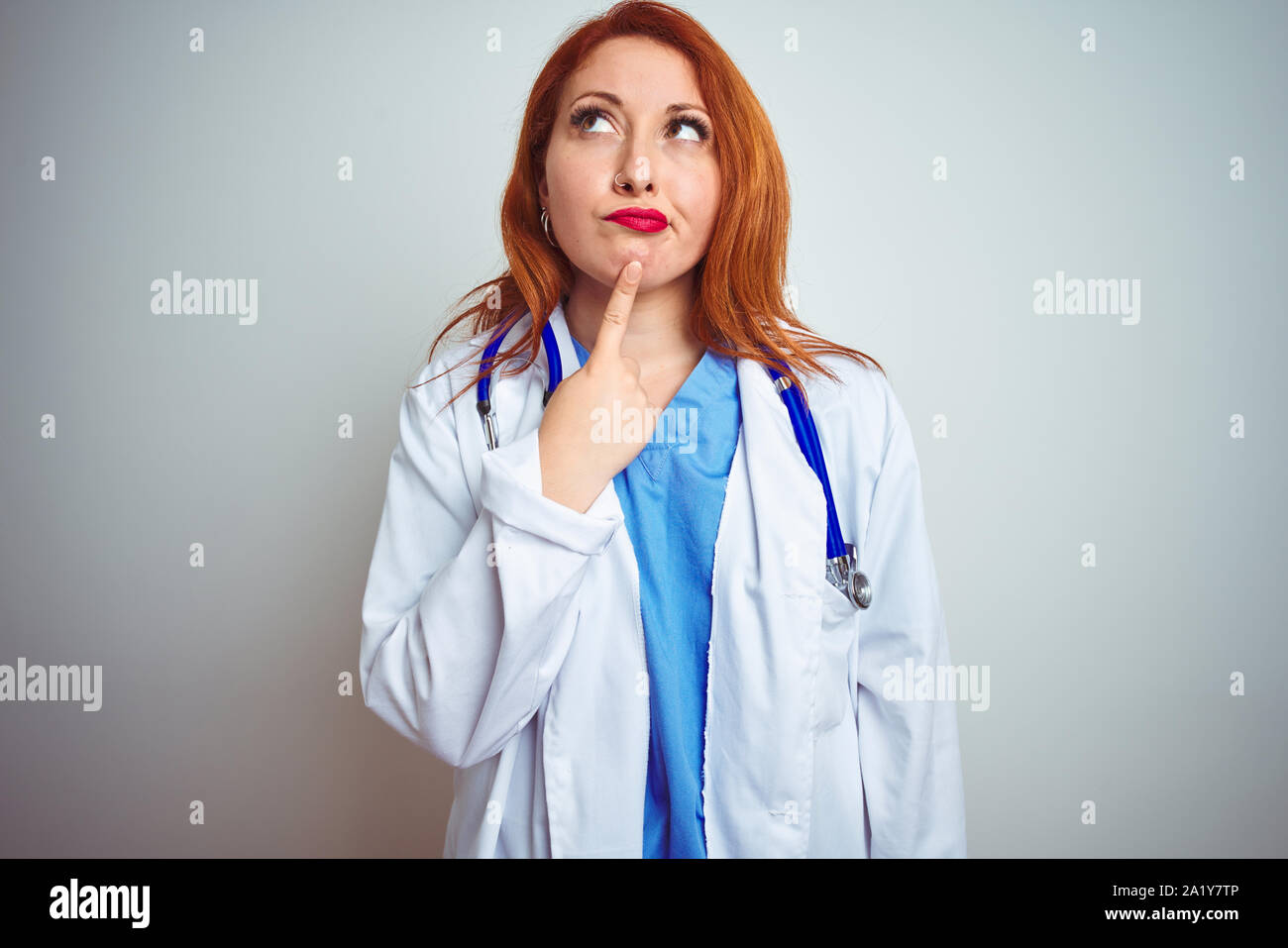 Young redhead doctor woman using stethoscope over white isolated ...