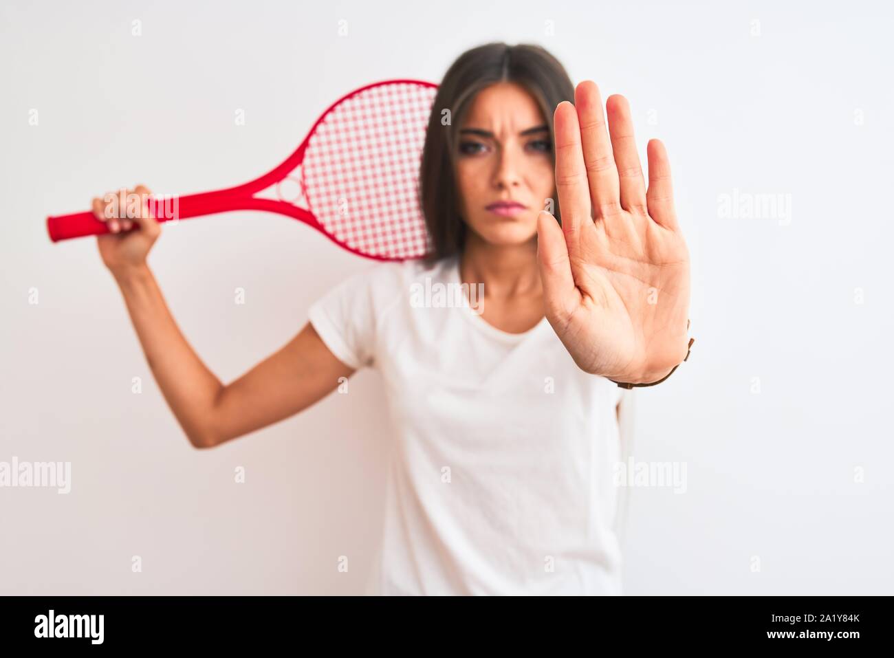 Beautiful sportswoman playing tennis using racket standing over ...