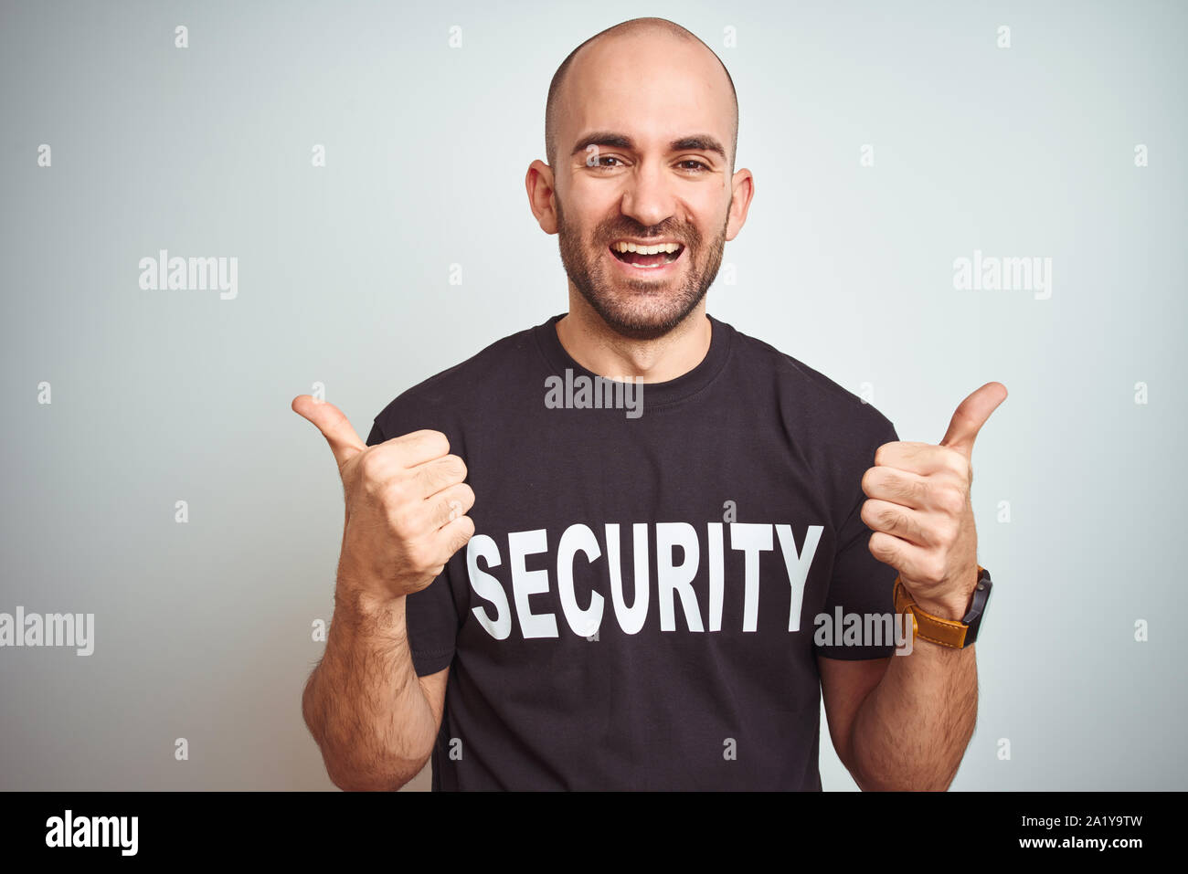 Young safeguard man wearing security uniform over isolated background ...