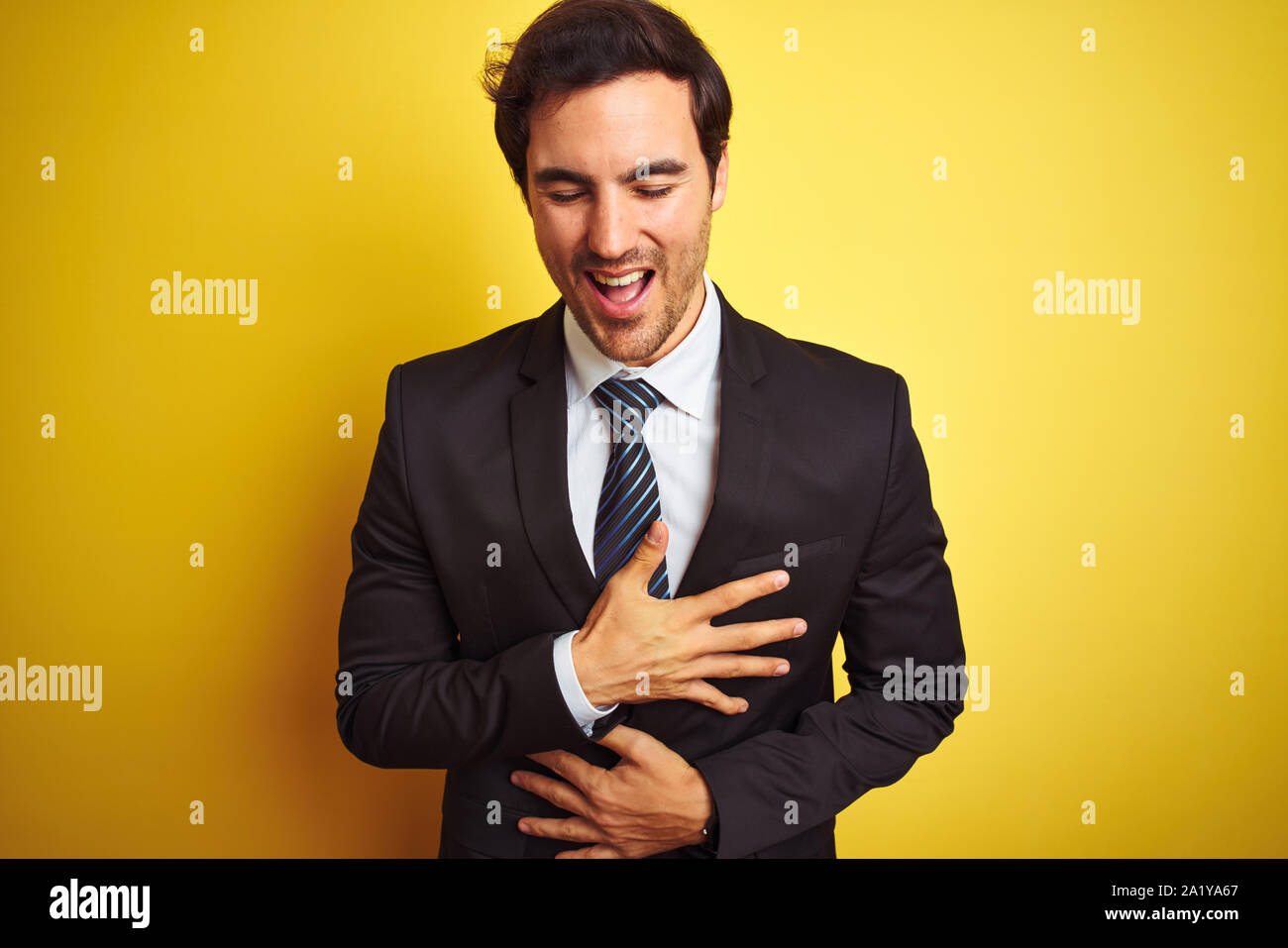 Young handsome businessman wearing suit and tie standing over isolated ...